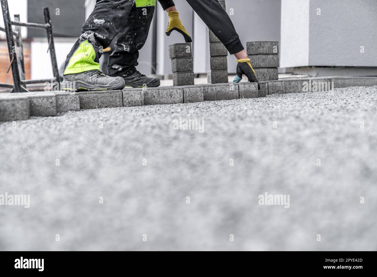 laying interlocking pavers during the construction of sidewalks and ...