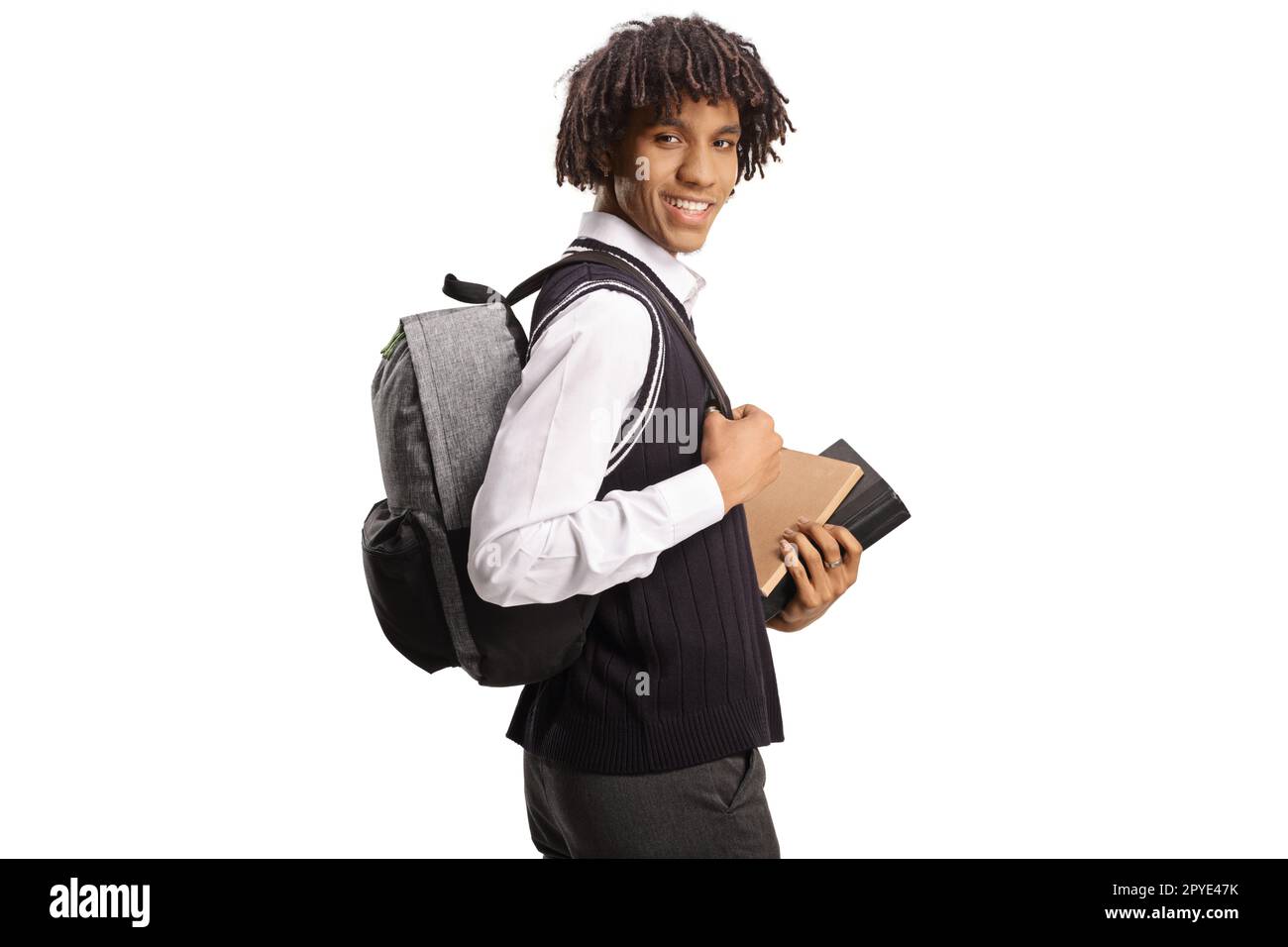 African american male student holding books and looking over shoulder ...