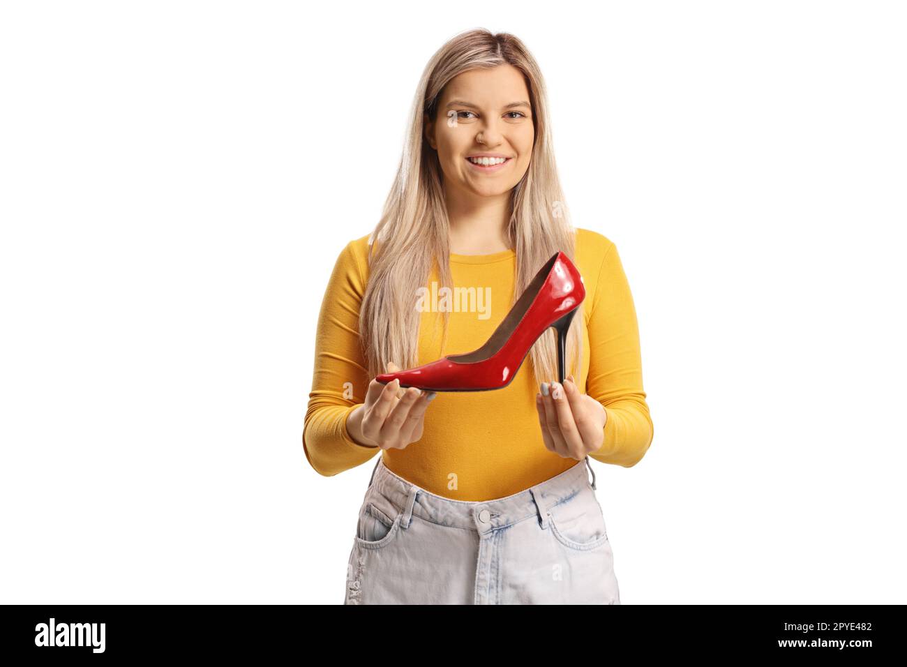 Happy young casual female holding a red high heel shoe and smiling ...