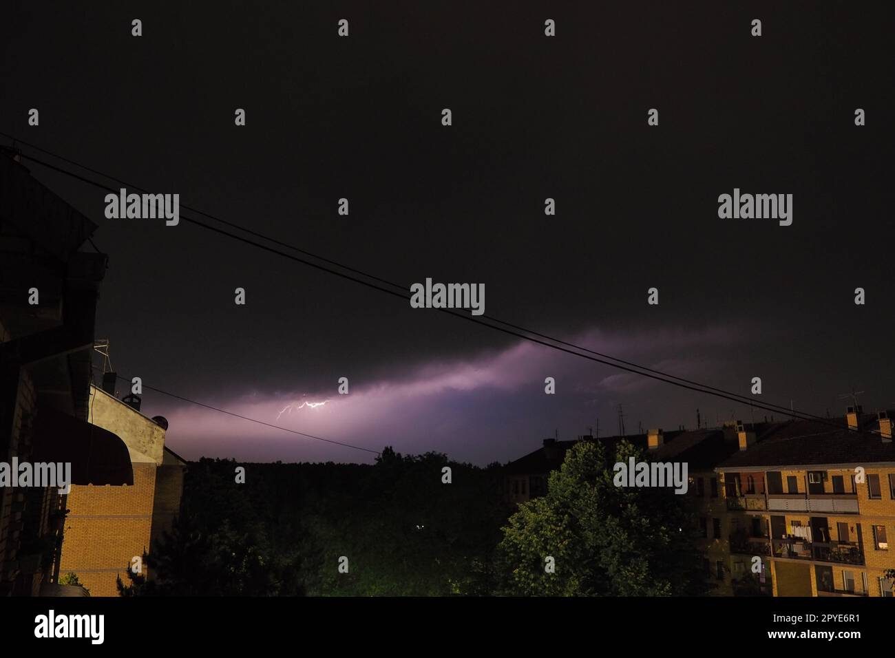 Thunderstorm at night over the city. Flashes of lightning and low ...
