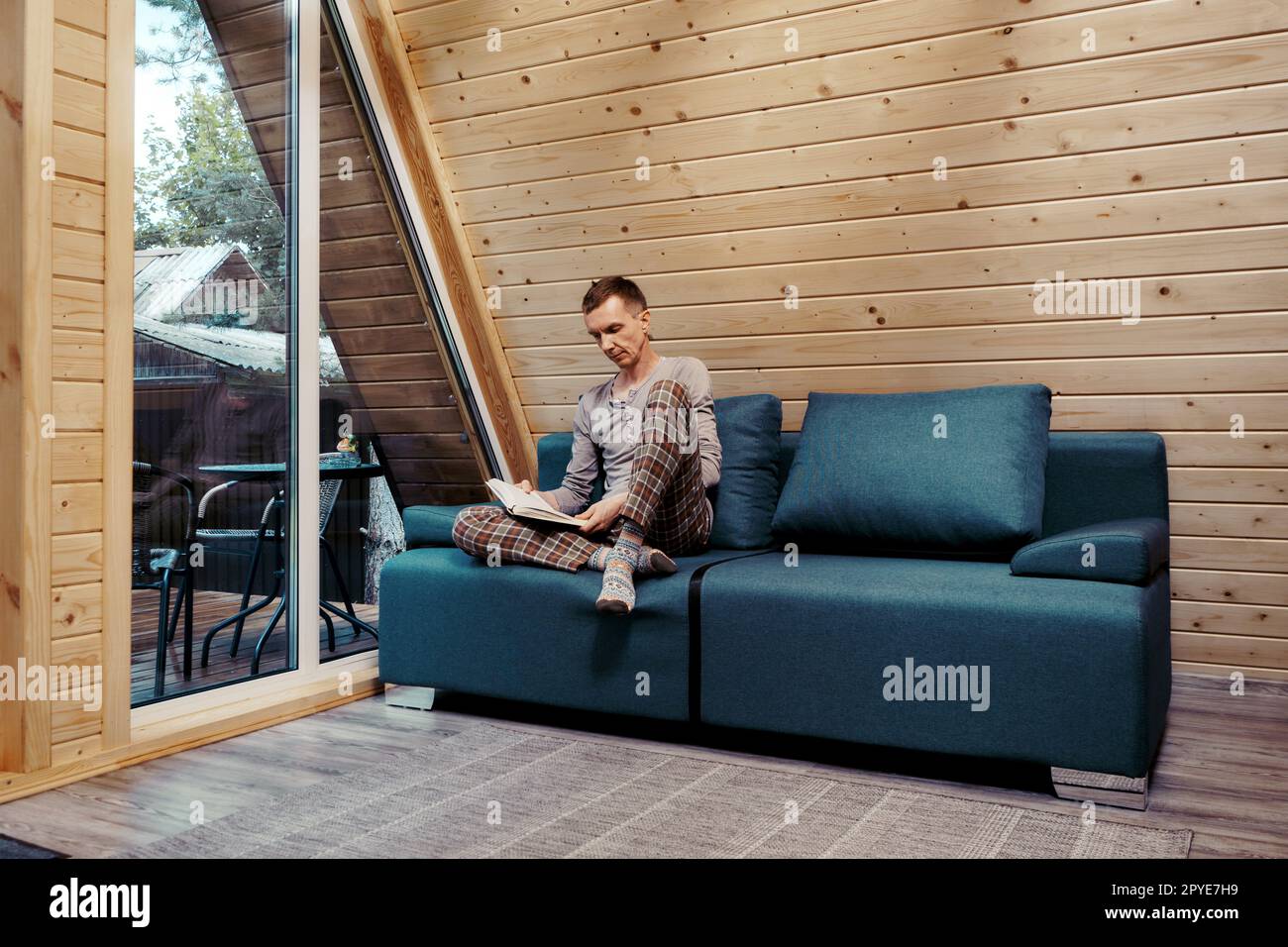 Mature man sits on sofa hi-res stock photography and images - Alamy