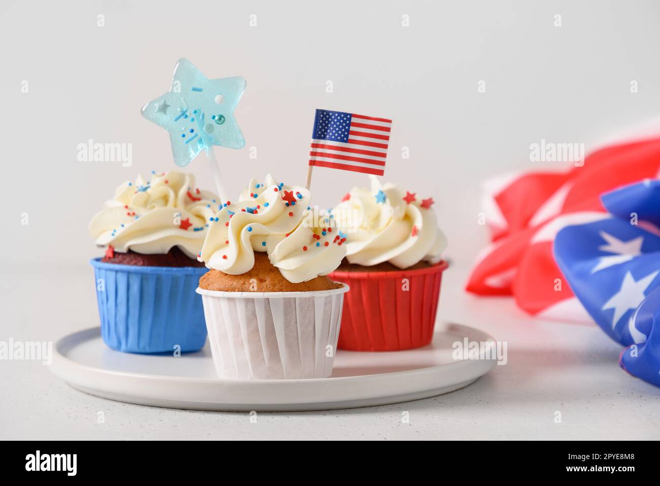 Traditional American sweet cupcakes with festive stars and USA flag on ...