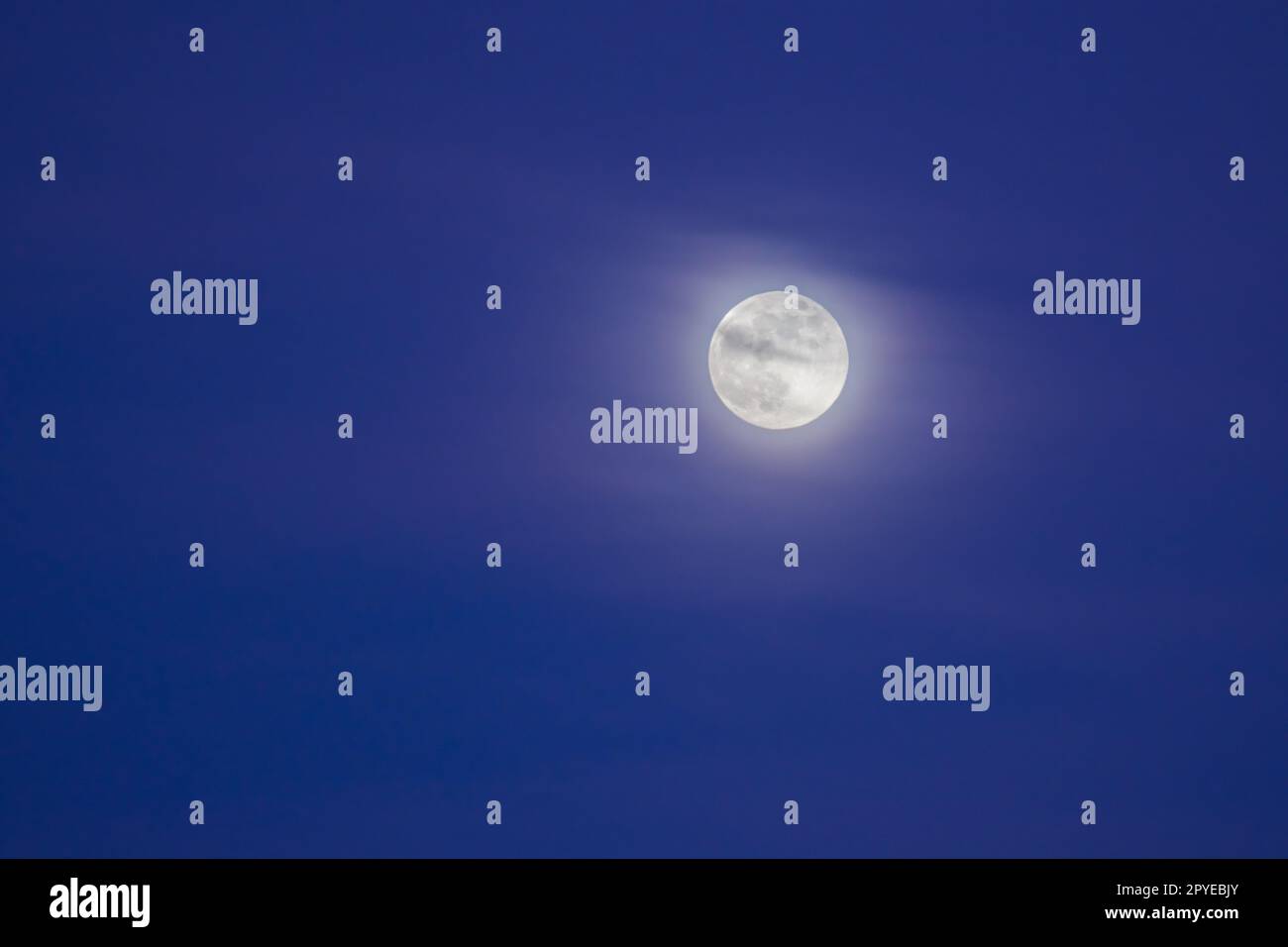 moon with soft clouds on the sky during blue hour Stock Photo - Alamy