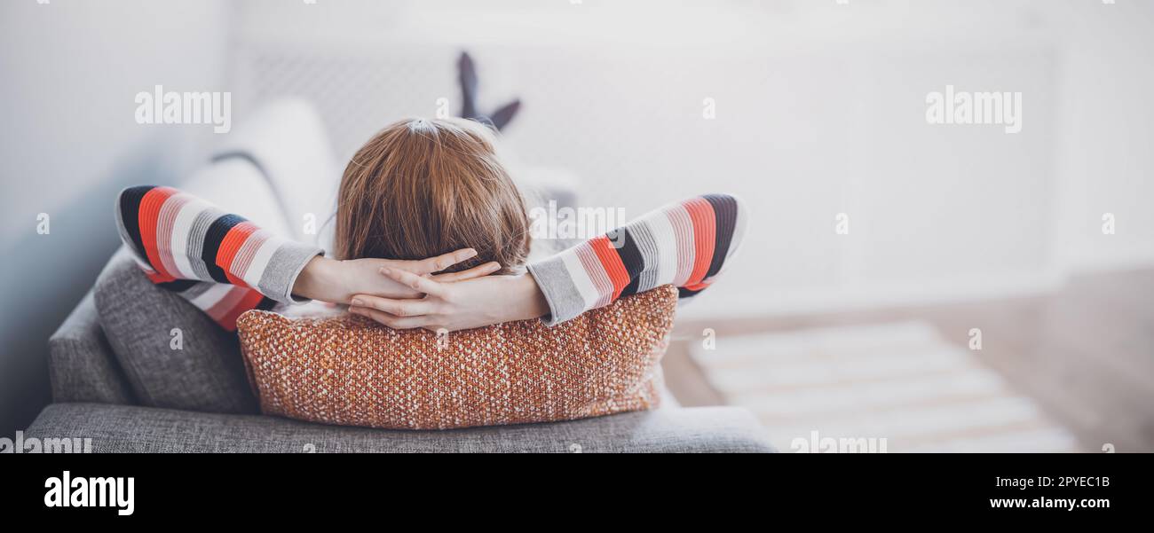 Tired woman lying down on the couch after workday Stock Photo - Alamy