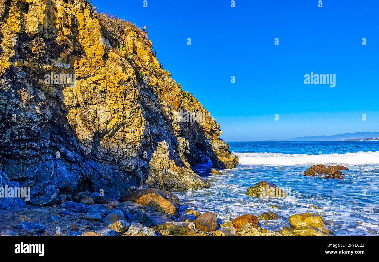 Beautiful rocks cliffs surfer waves at beach Puerto Escondido Mexico ...