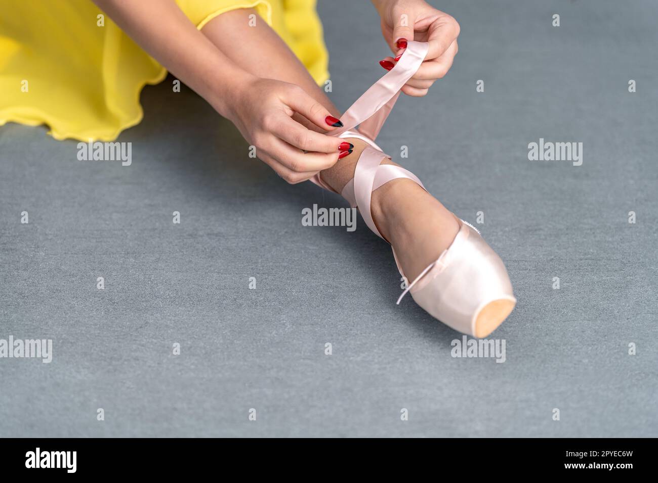 lacing of ballet shoes on the feet of a ballerina Stock Photo - Alamy