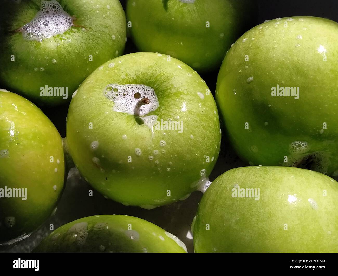 Washing fruit. Soapy green apples. Washing fruits and vegetables for ...