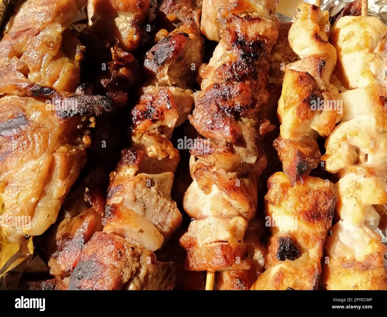 Grilled chicken, pork skewers on sticks. Food from the restaurant. Dish ...