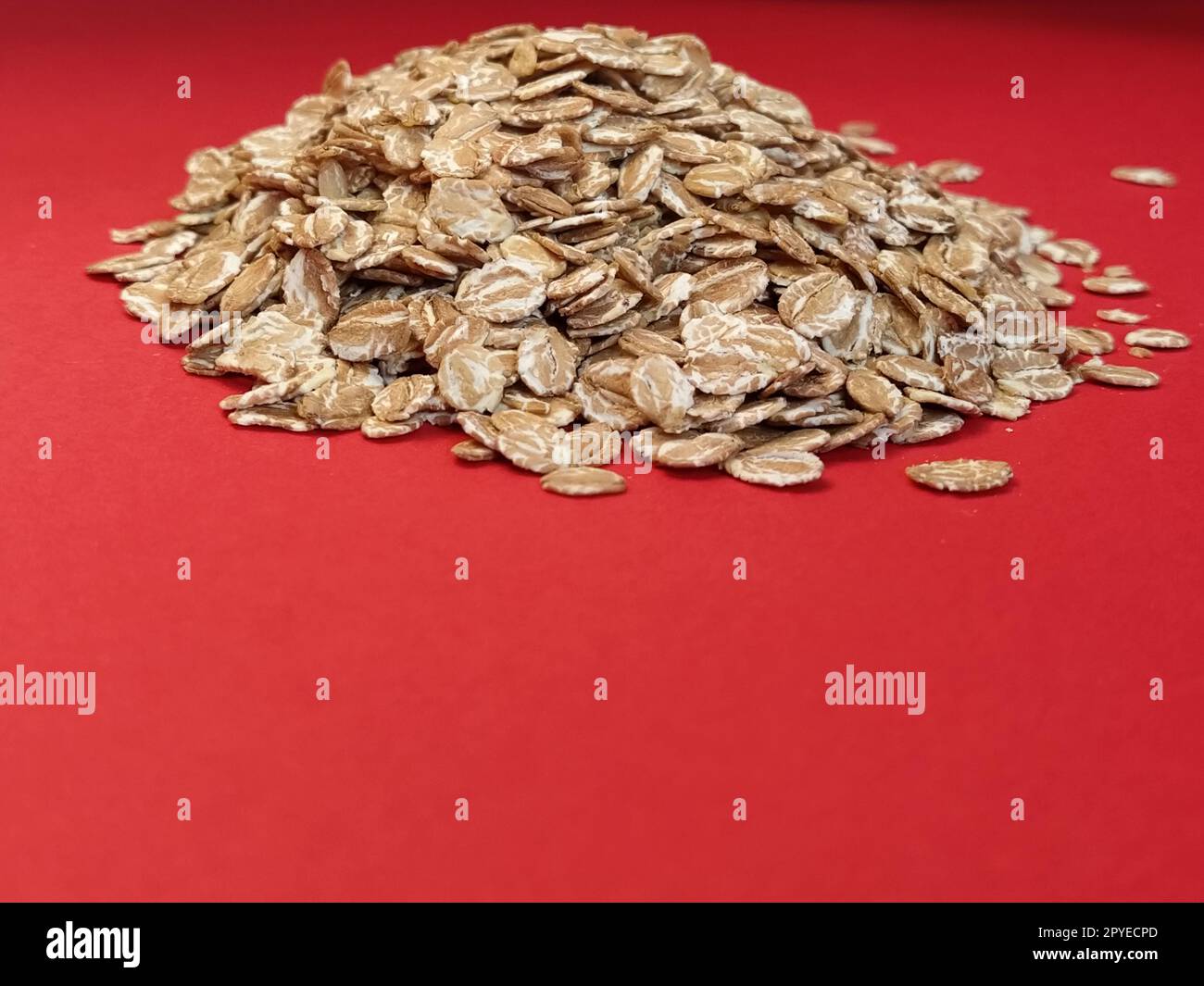 Rye flakes on a red background. Healthy eating and vegetarianism ...