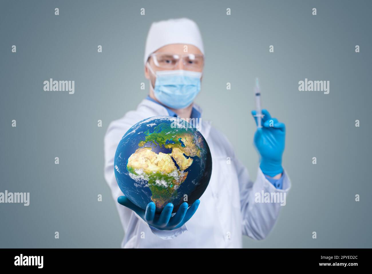 Doctor hold a earth globe in hands and a medical syringe with vaccine ...