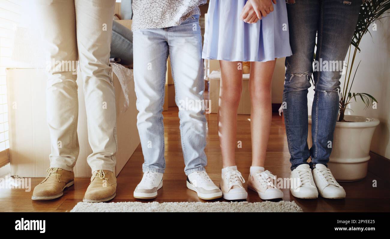 Were a family of four. a family standing in a line together at home ...