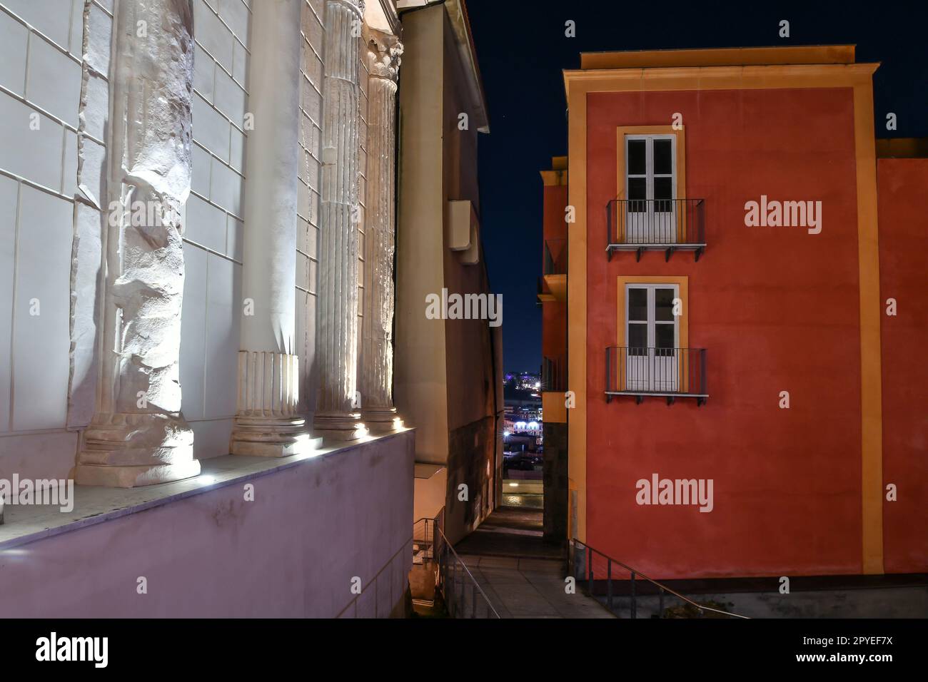 A wall of a medieval church built between the columns of an ancient ...