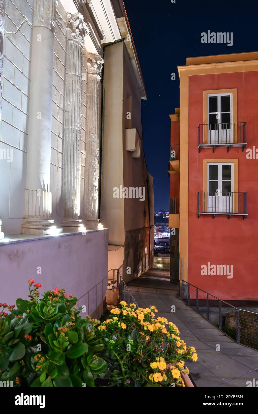 A wall of a medieval church built between the columns of an ancient ...