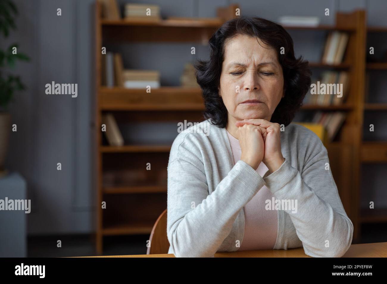 Sad tired ill sick lonely disappointed older senior woman sitting at ...
