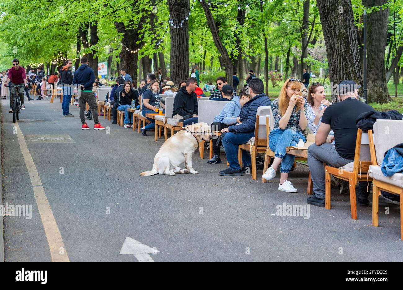 Bucharest, Romania - April 2023: Urban scene with people sitting at ...