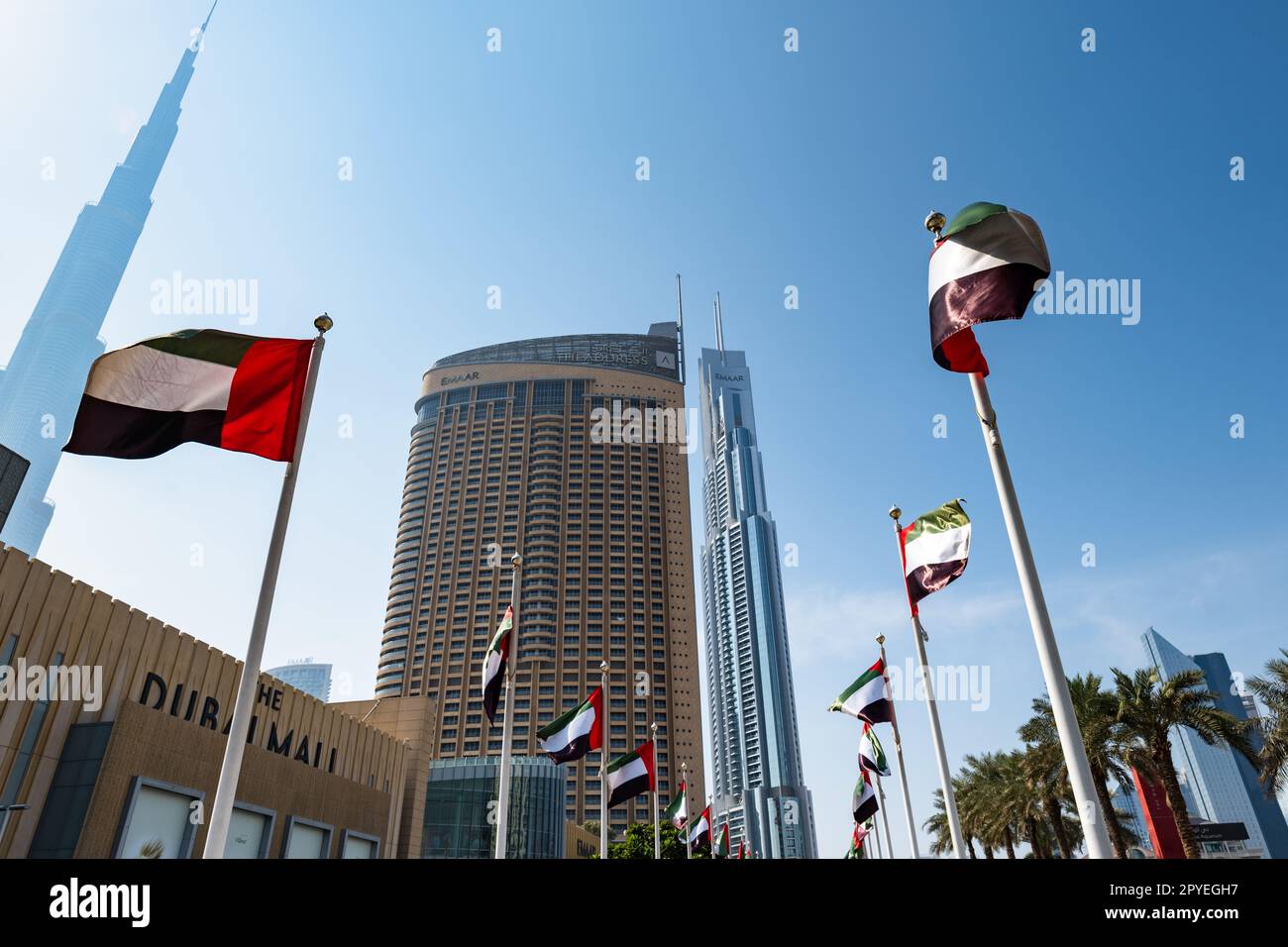 Dubai, UAE - November 2022: UAE flags waving besides Dubai Mall and ...