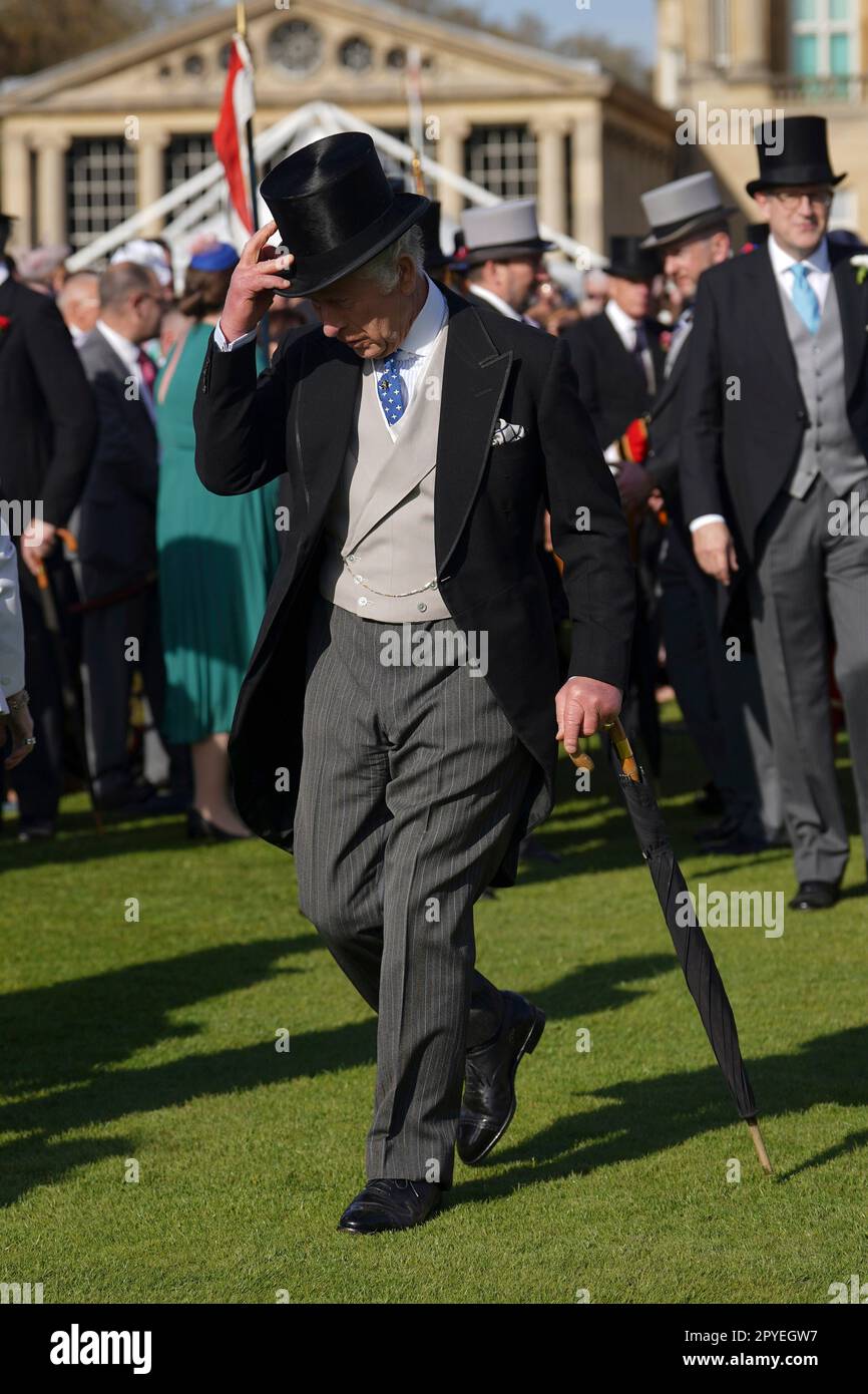 Guests watch as Britain's King Charles III walks, during a Garden Party ...