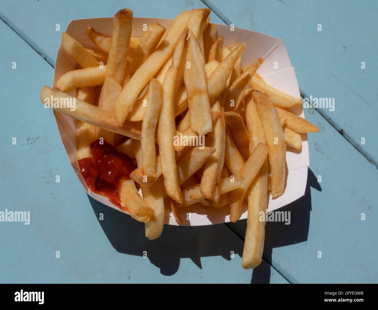 A Portion Of Takeway French Fries On A Camping Table By The Beach Stock ...