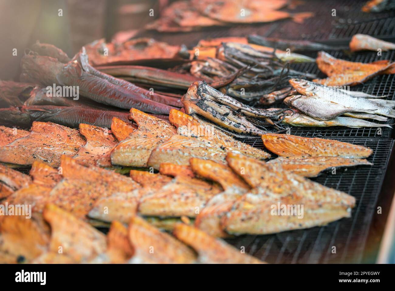 Fish of different varieties are grilled. Fishing season Stock Photo - Alamy