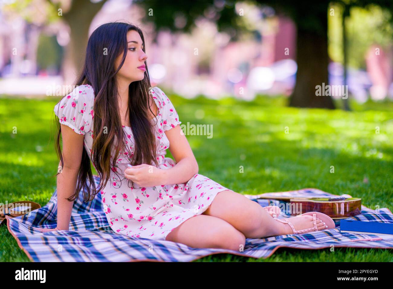 Teenage Latina Singer Songwriter Sitting on Blanket with Ukulele Stock ...