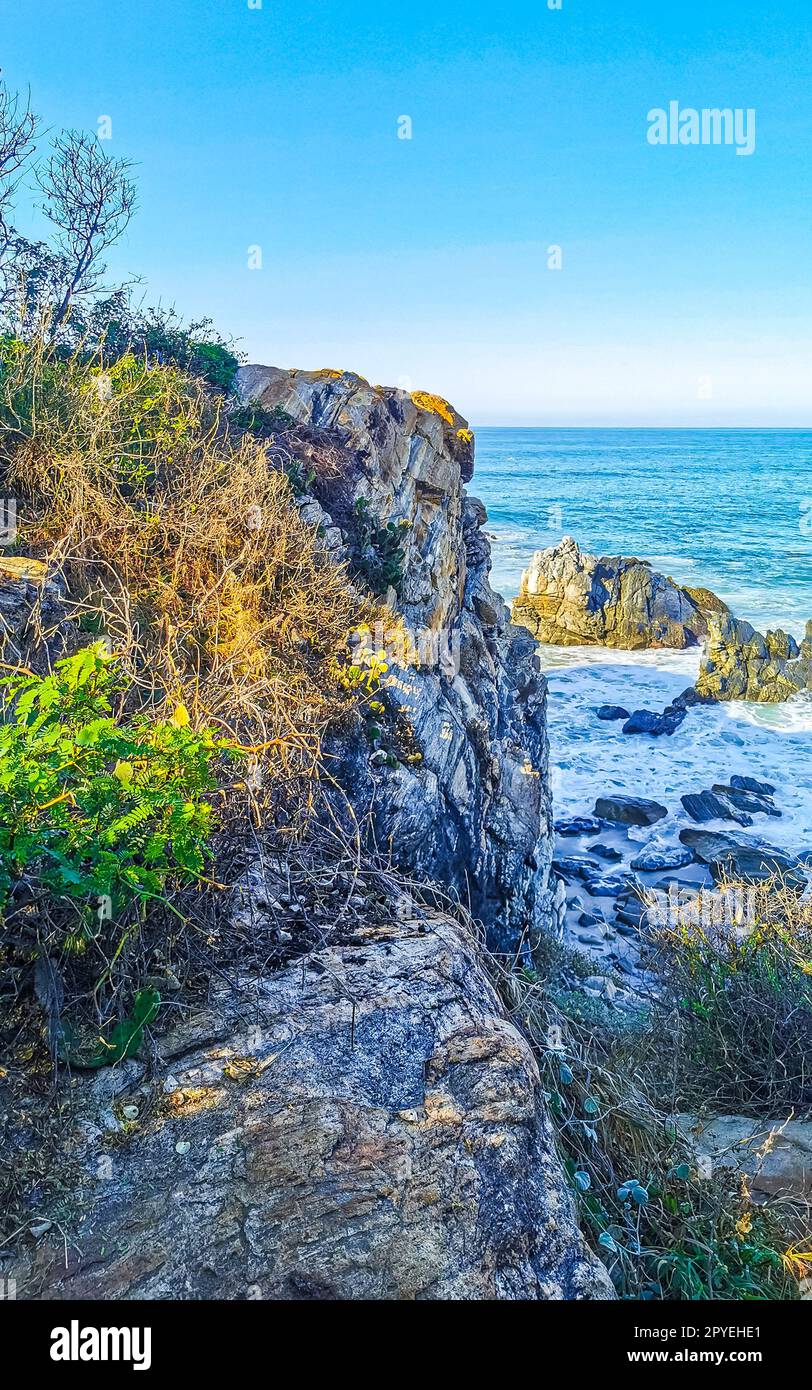 Beautiful rocks cliffs surfer waves at beach Puerto Escondido Mexico ...