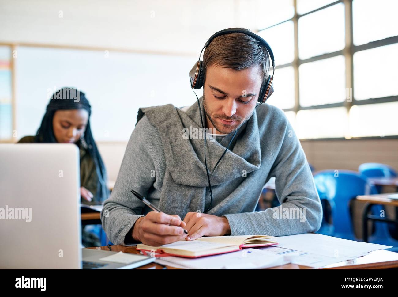Hes diligent and dedicated. a handsome young university student taking ...