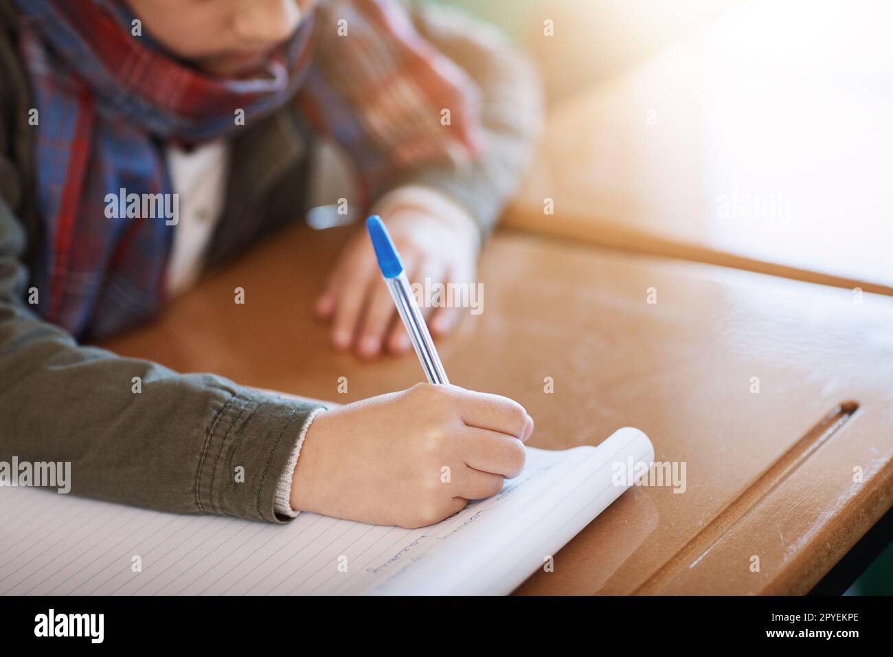 Writing down her dreams. an unrecognizable elementary school girl ...