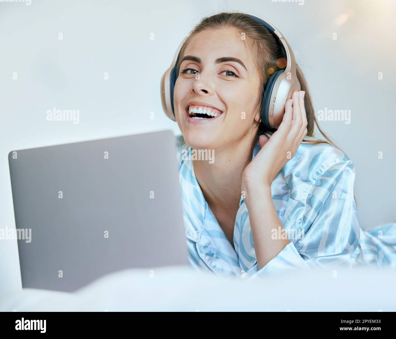 Woman, student and headphones with laptop for music, streaming and ...