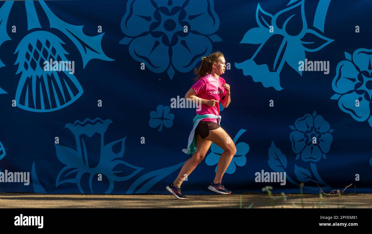London, UK. 3 May 2023. A runner passes decorative security screens in ...