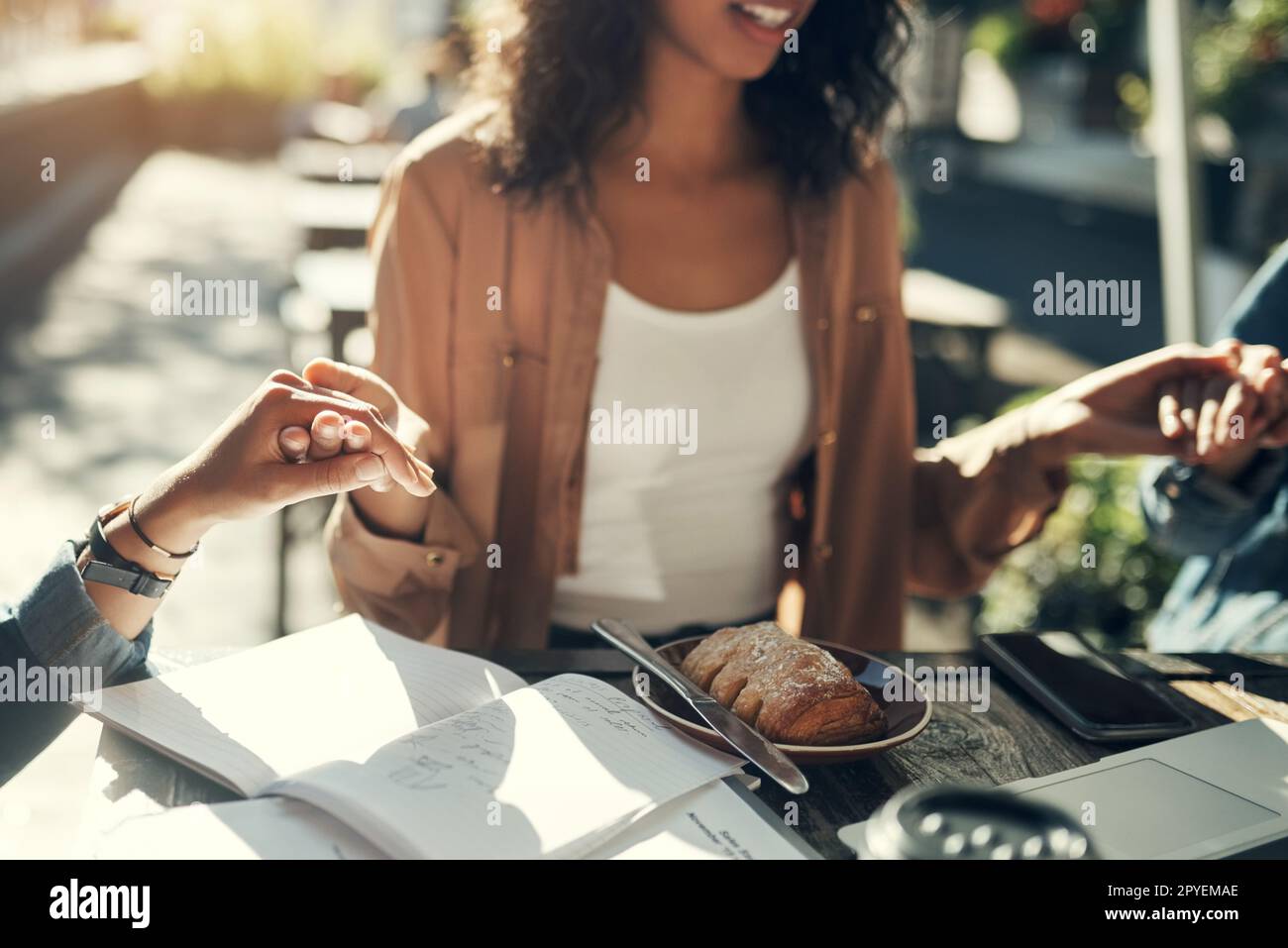 Blessing the food. a group of creative employees holding hands and ...