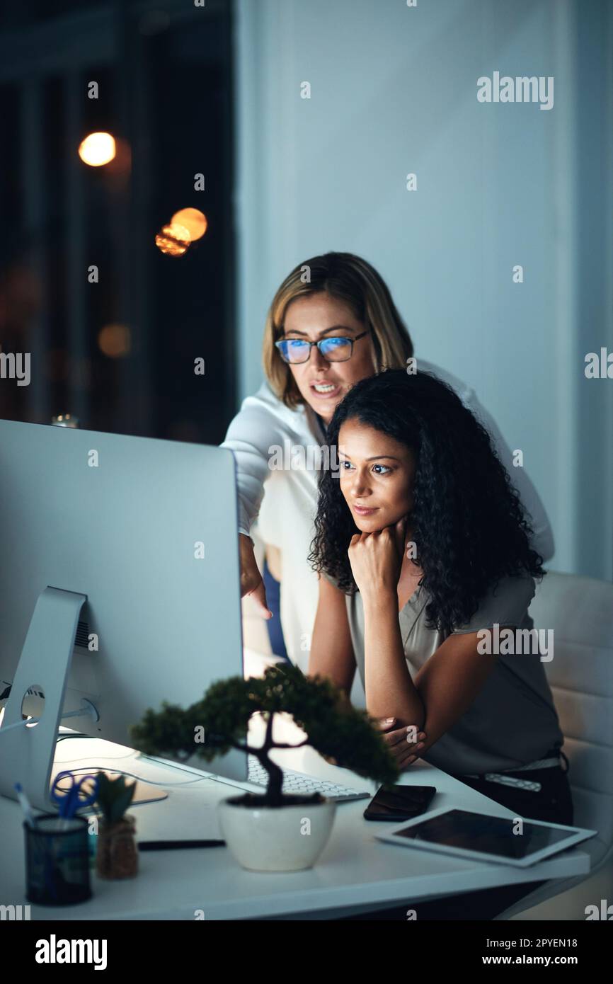 Productivity before anything else. two colleagues using a computer ...