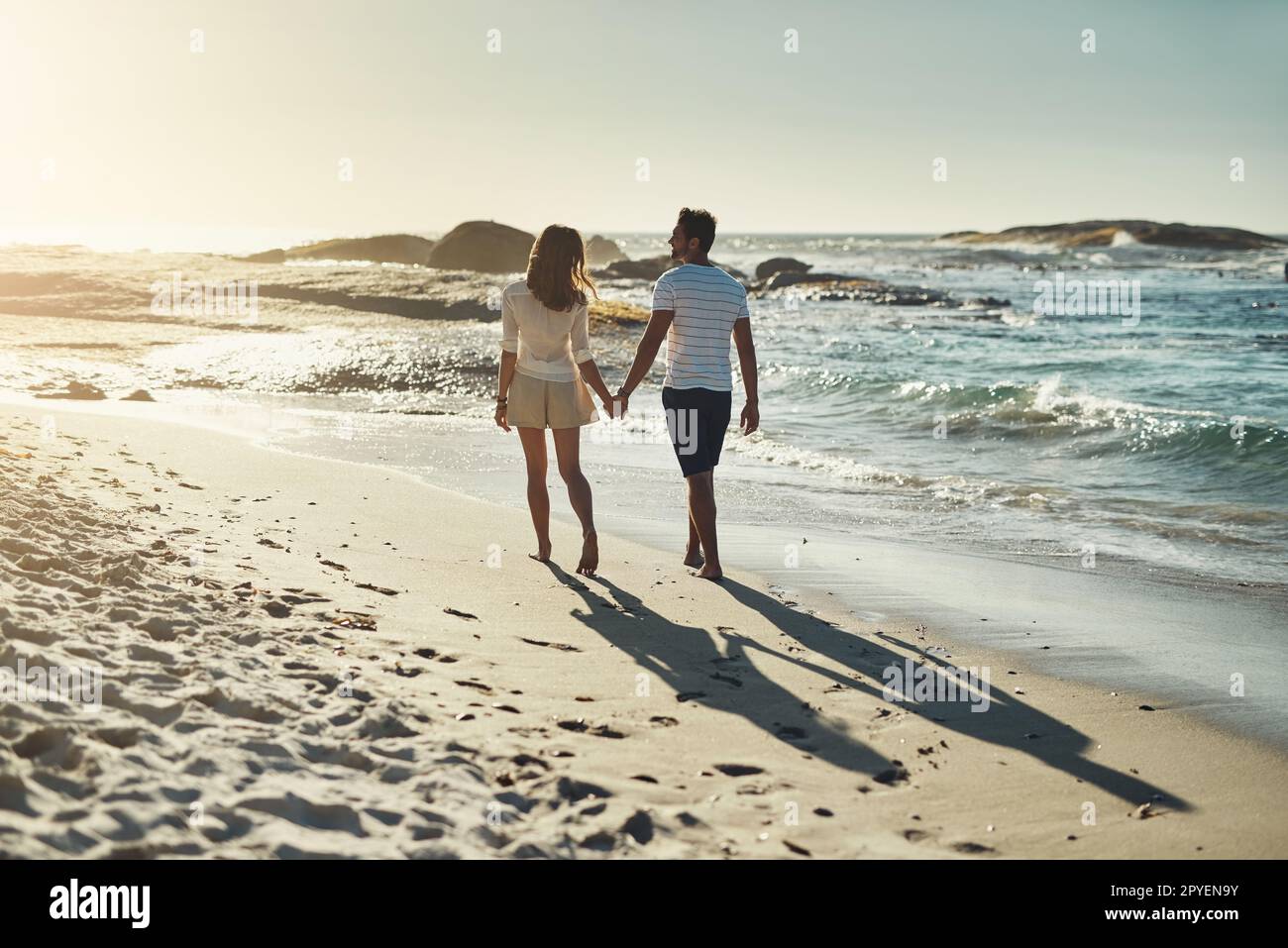 Long shot of people walking on beach hi-res stock photography and images - Alamy