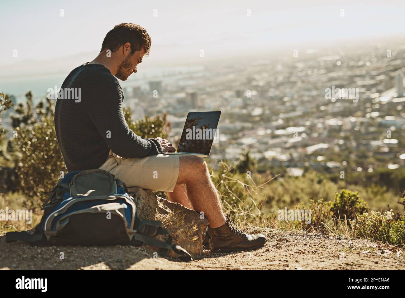 Starting a new blog on hiking. a young man using his laptop while ...