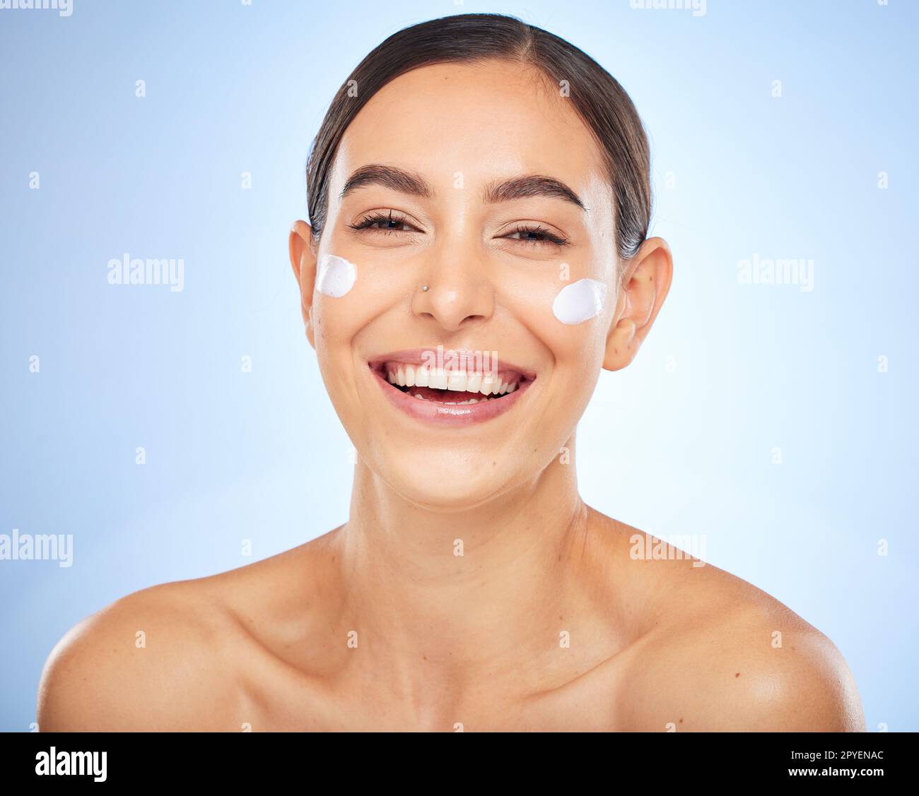 Portrait, skincare and moisturizer with a model woman in studio on a ...