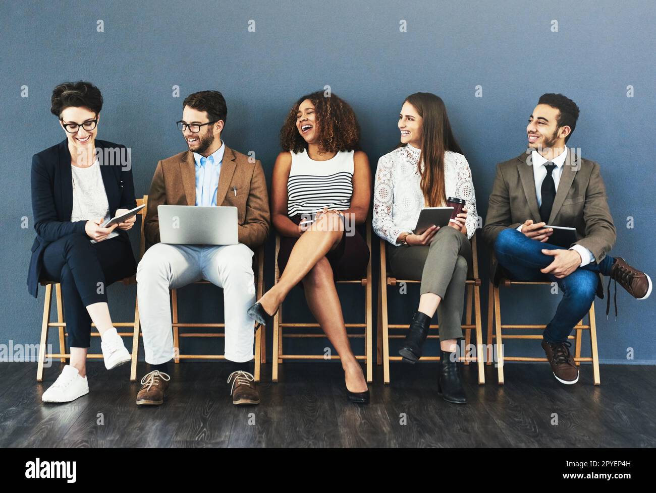 Who said waiting has to be boring. Studio shot of a group of ...