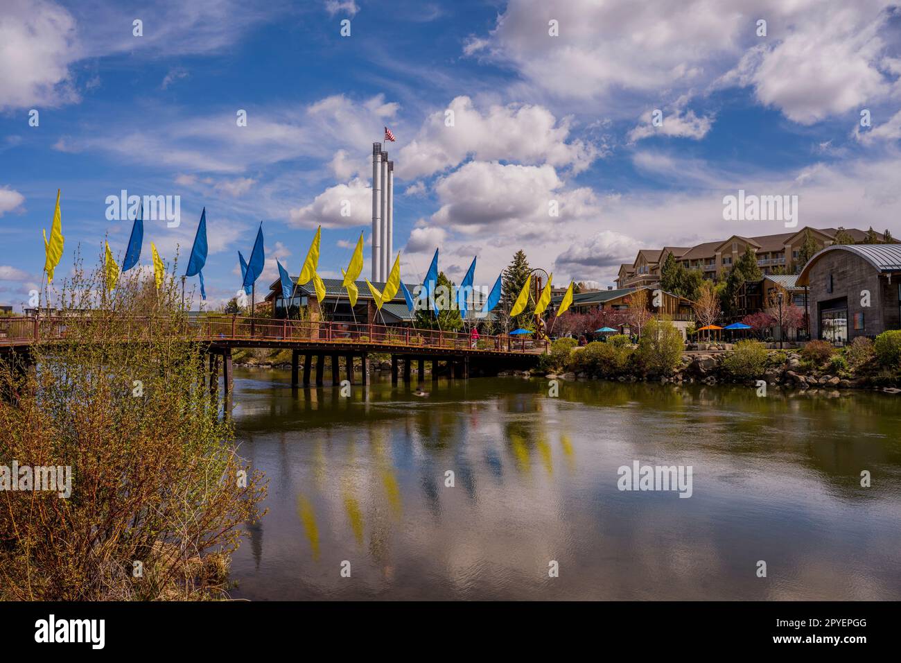 A pedestrian bridge decorated with flags over Deschutes River at the ...