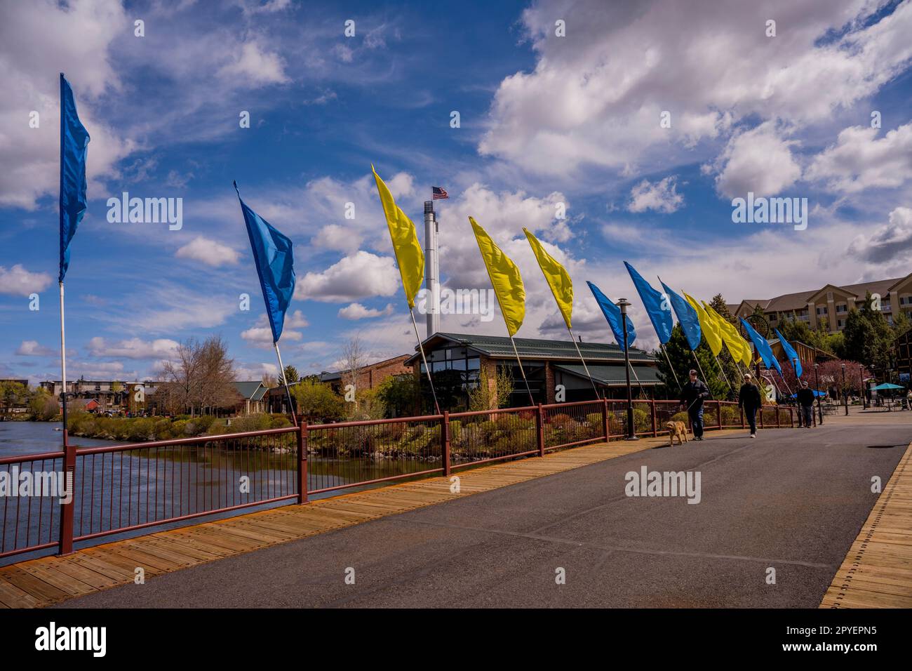 A pedestrian bridge decorated with flags over Deschutes River at the ...