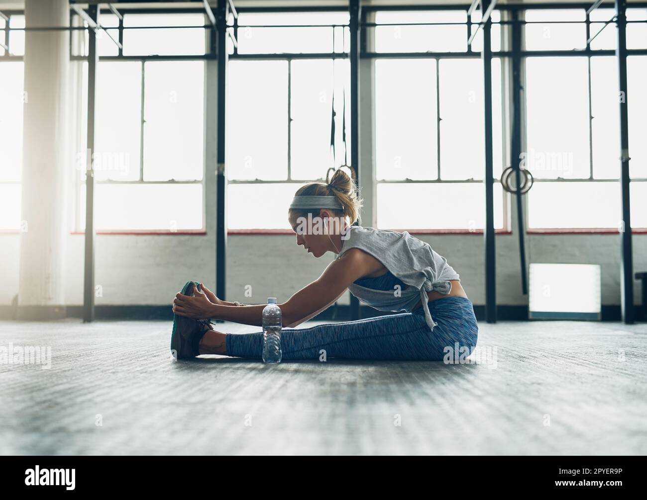 Good stretch means great workout. a young attractive woman stretching ...