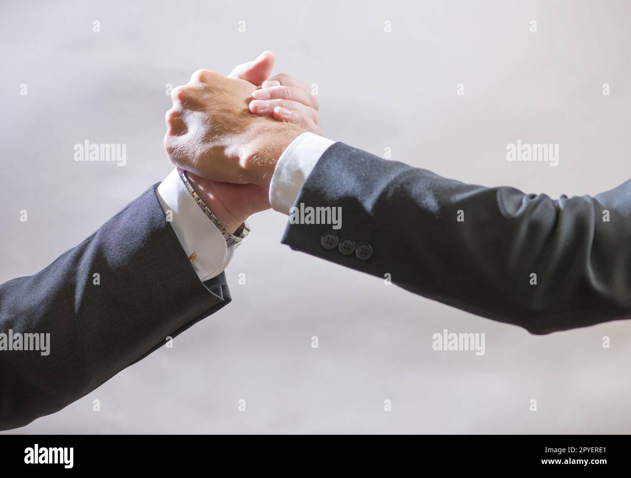 Two business partner to greet each other, branded handshake on gray ...