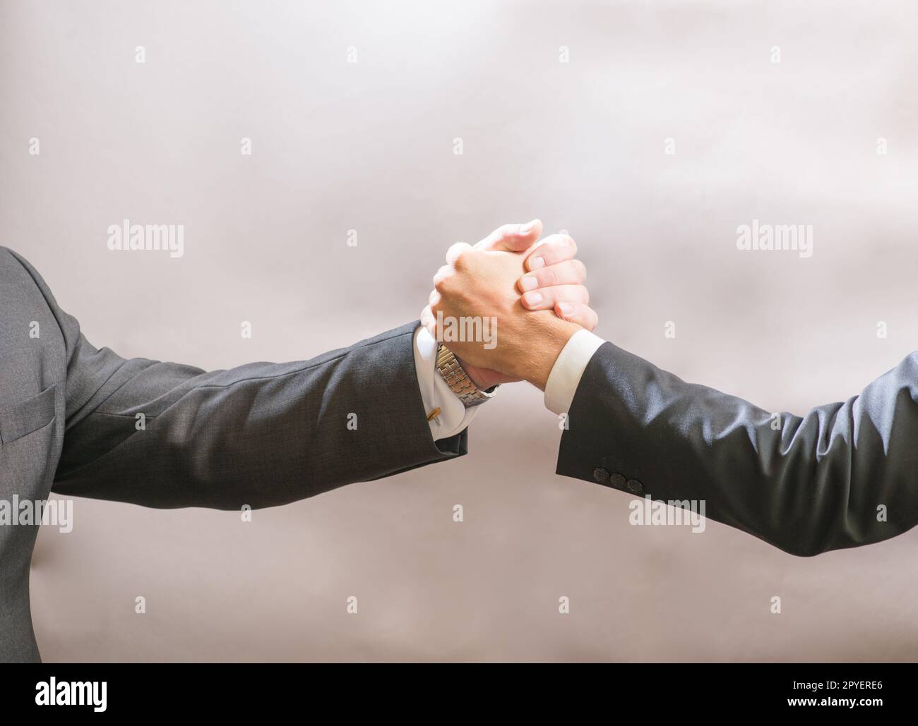 Two businessmen partner to greet each other, a firm handshake Stock ...