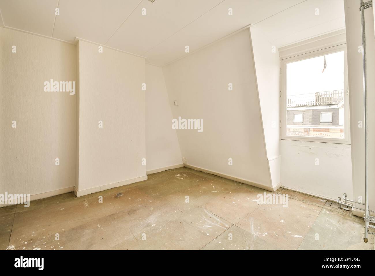 an empty room with white walls and no one person standing in the corner ...