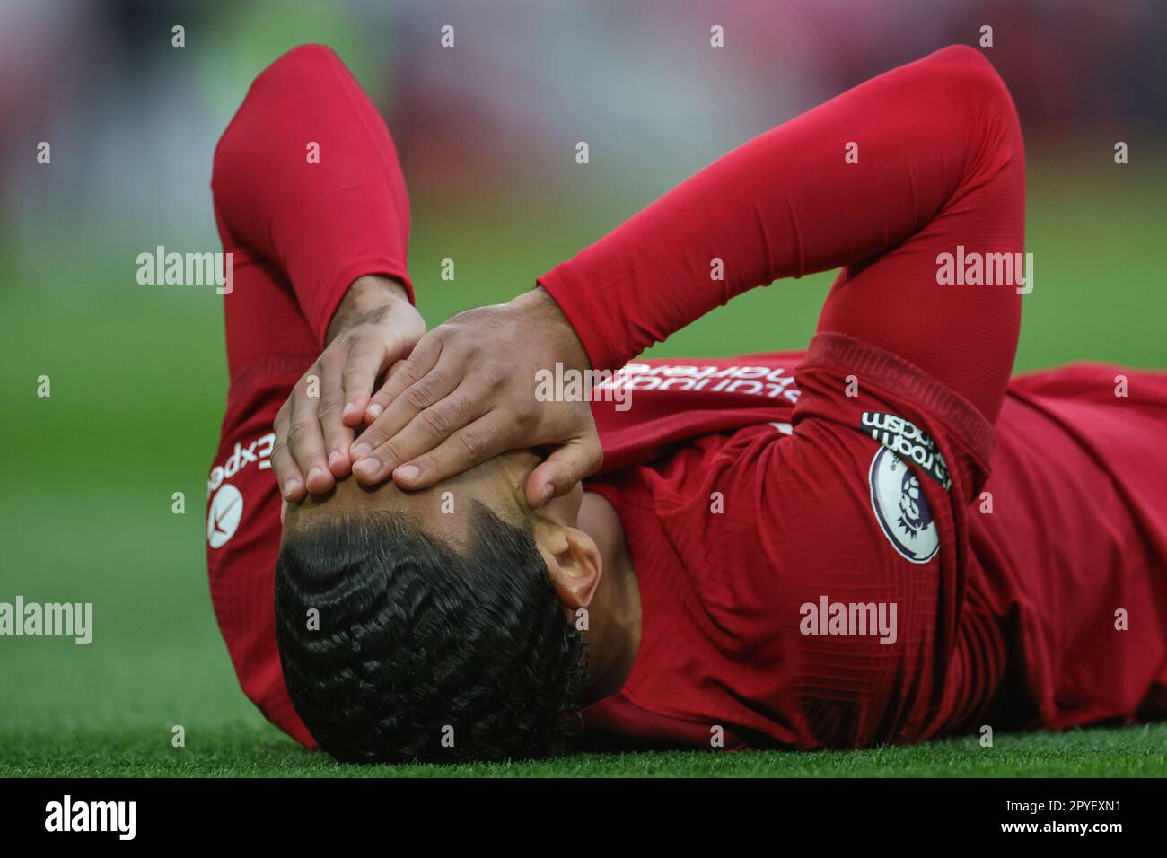 Virgil van Dijk #4 of Liverpool goes down holding his face after a ...