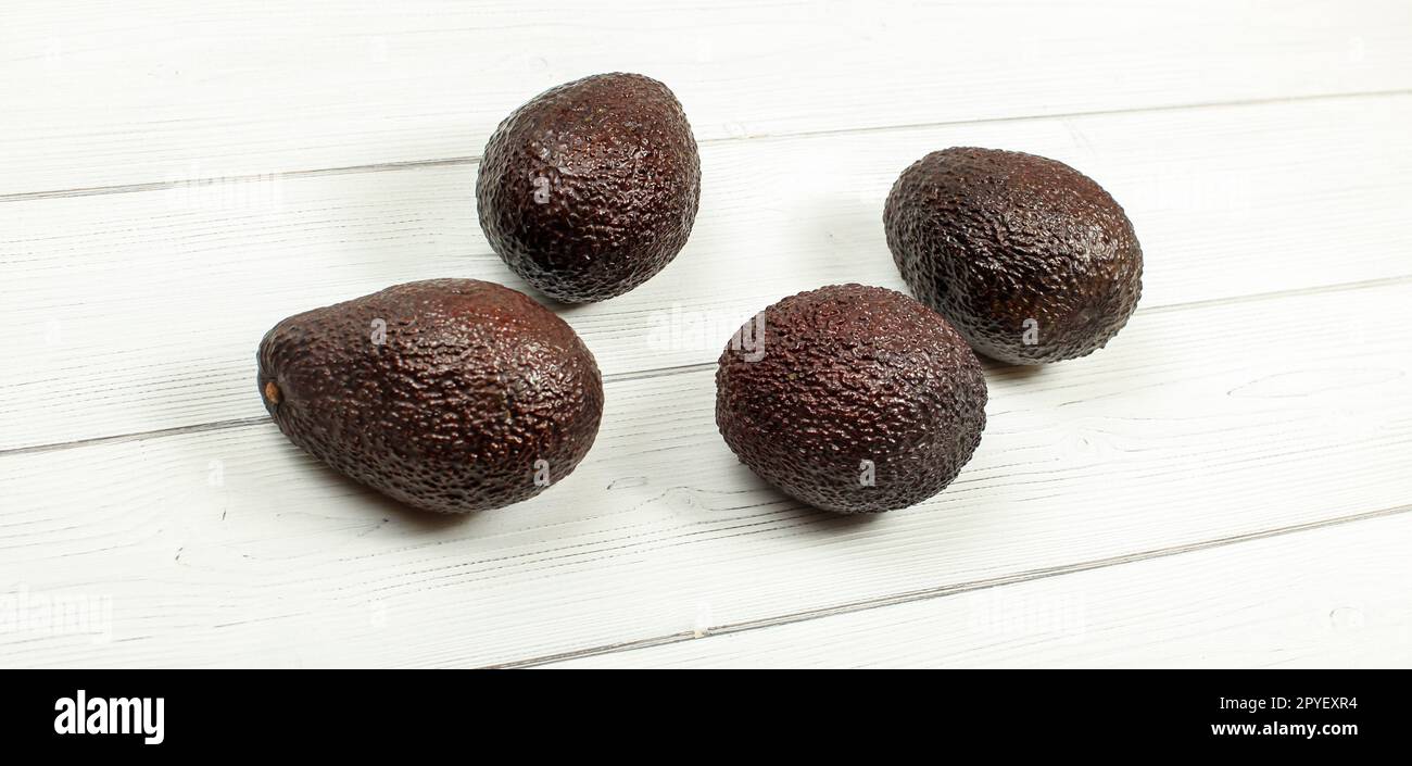 Whole avocados on white background hi-res stock photography and images ...