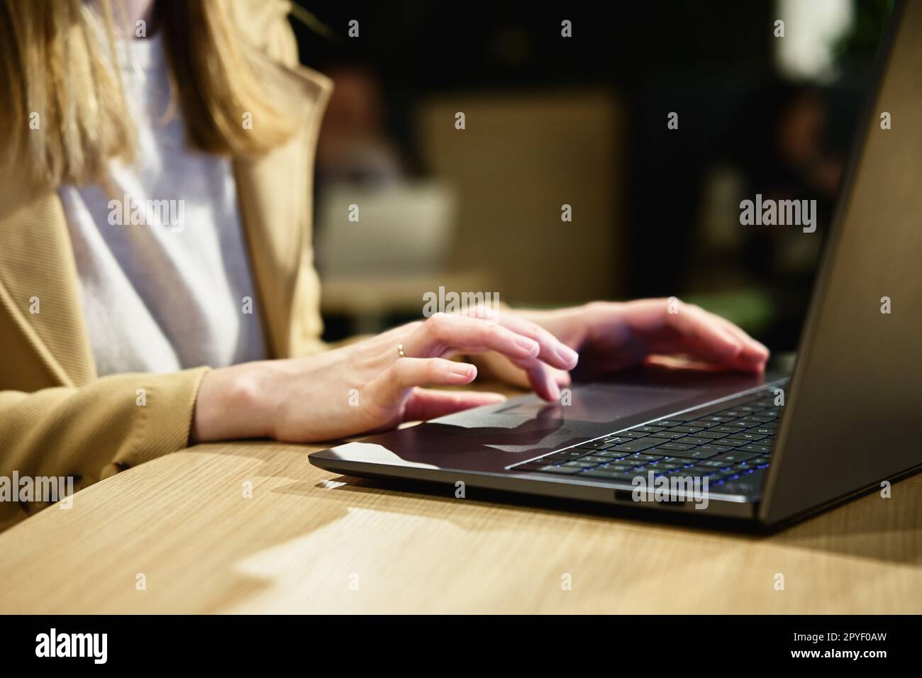 Female hands typing on laptop keyboard, close up. Woman using laptop in ...