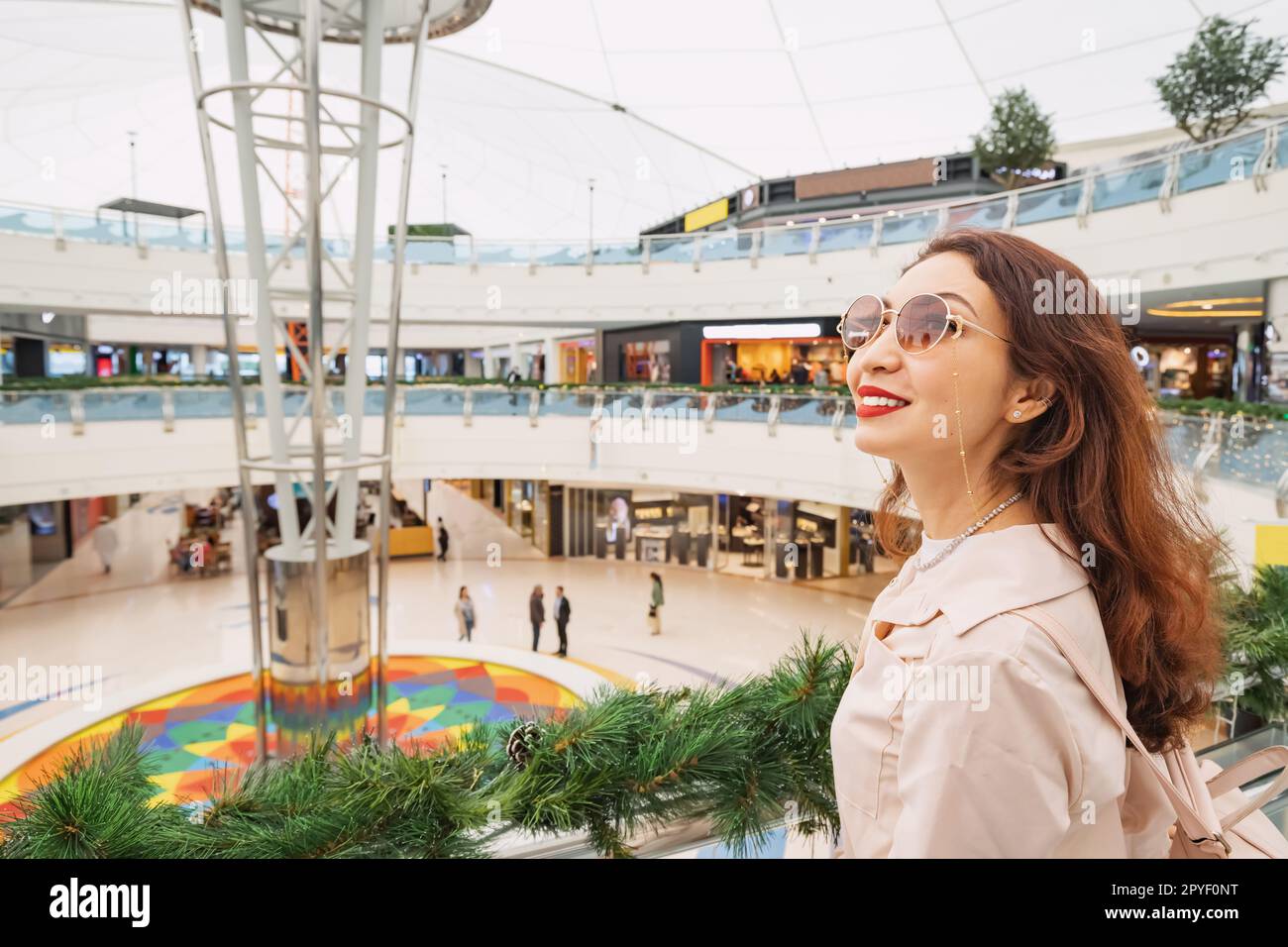 Happy stylish asian girl shopping in mall interior Stock Photo - Alamy