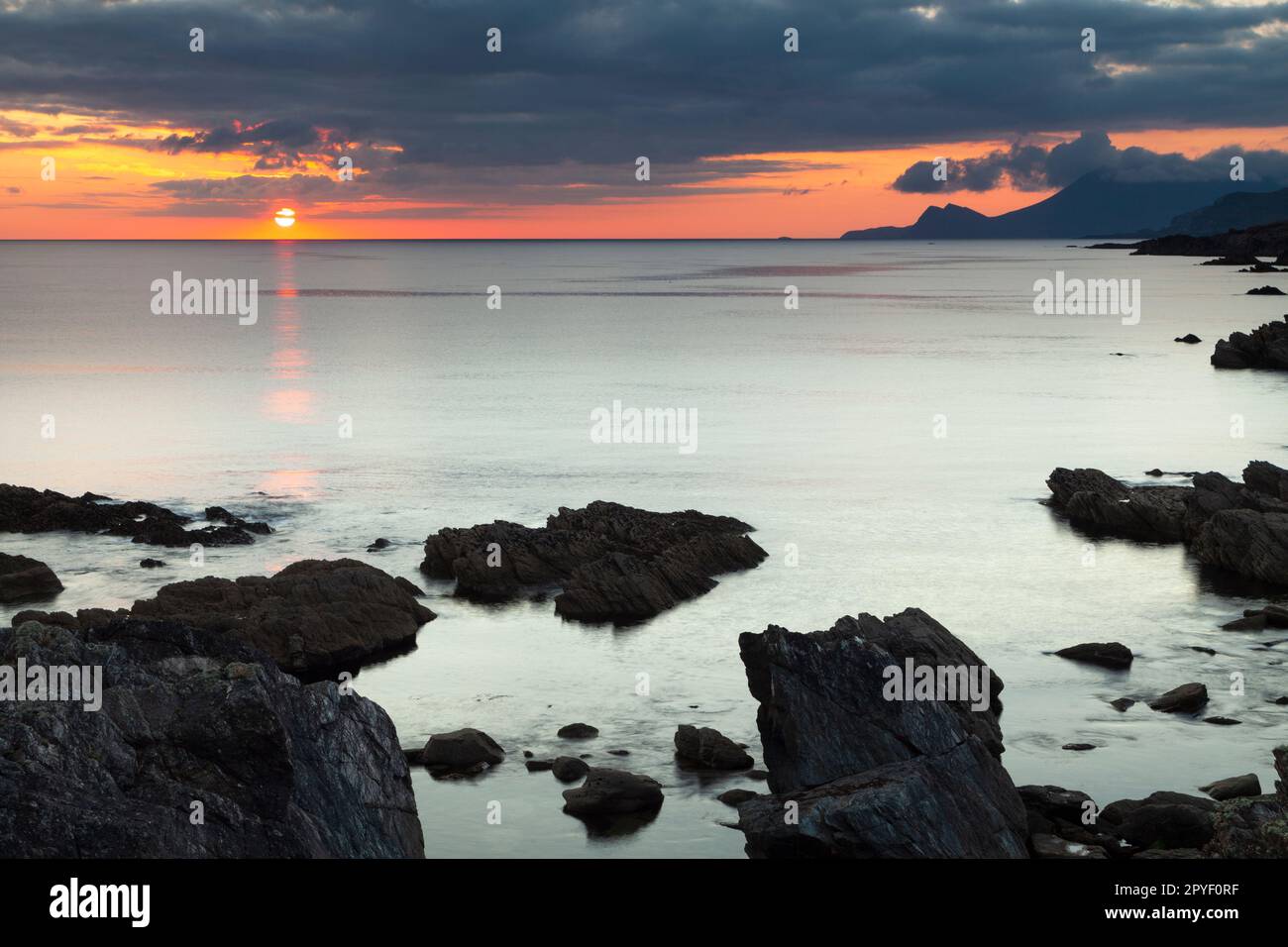 Setting sun on the horizon by Achill island on the Wild Atlantic Way in ...