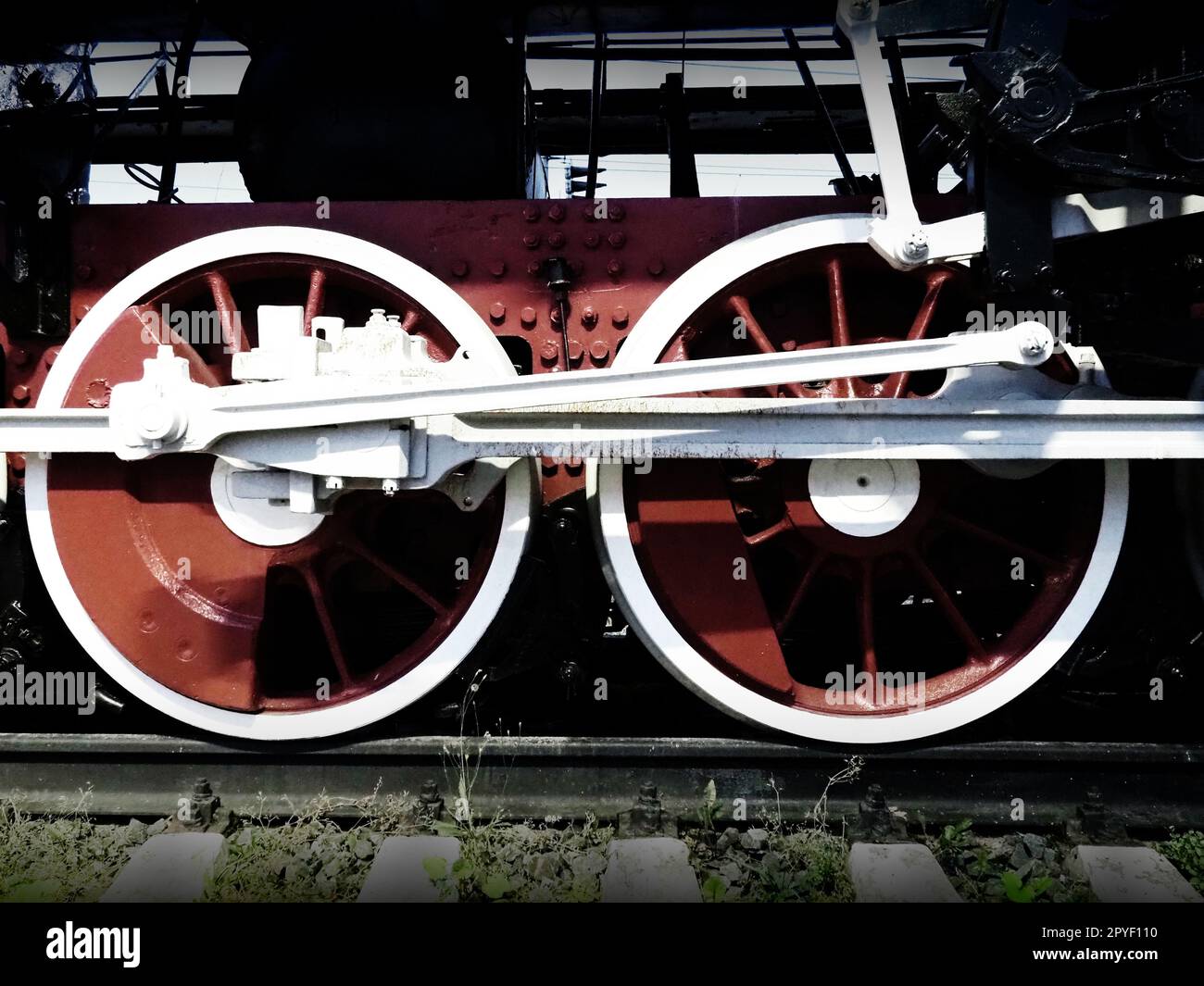 Retro vintage wheels of a locomotive or train close up. Red large heavy ...