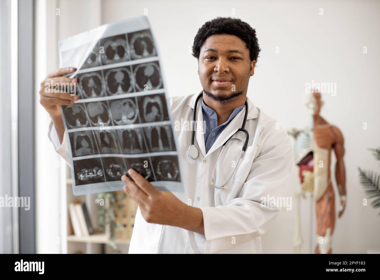 Confident african american man in doctor's coat with stethoscope ...