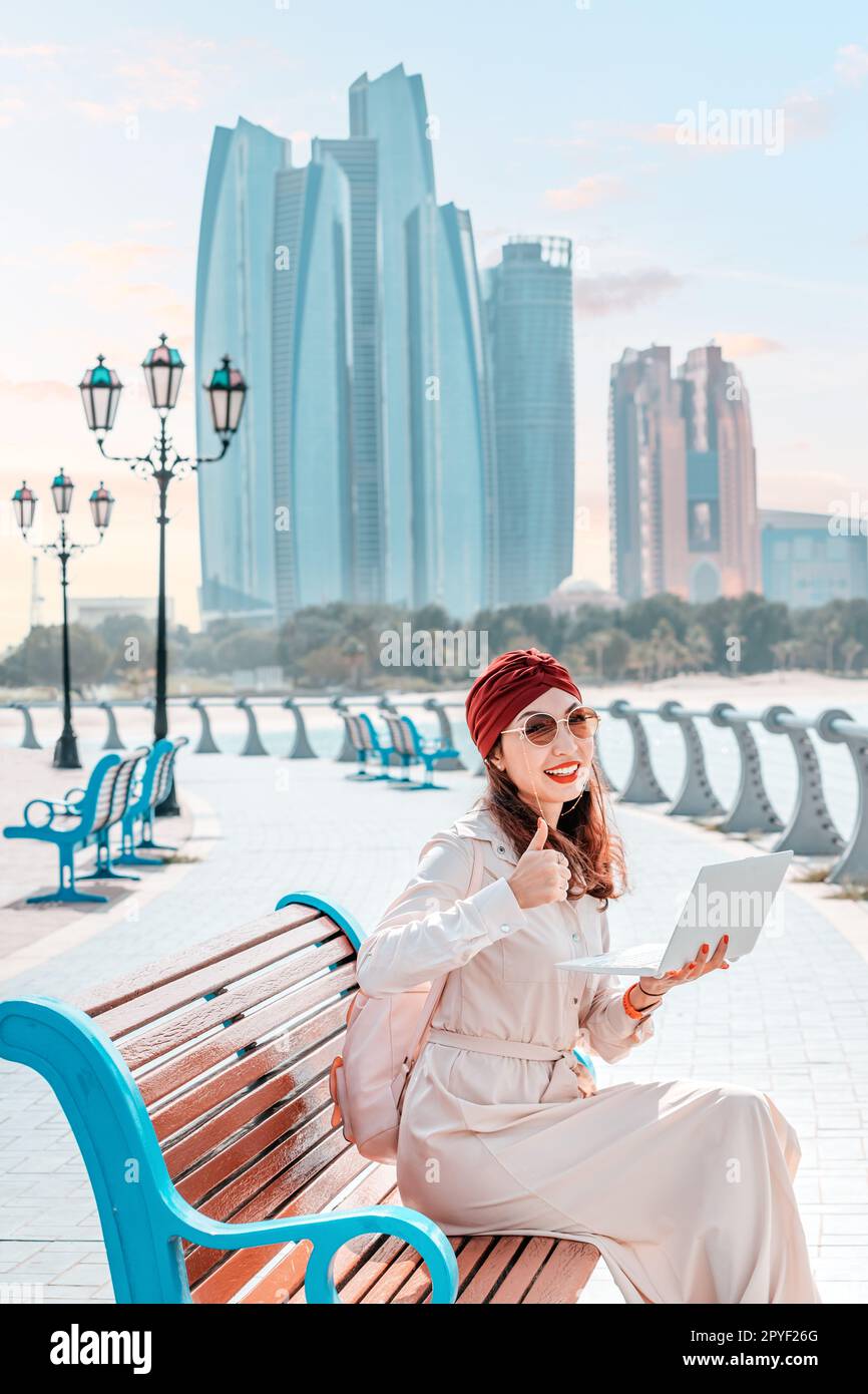 Combining work and pleasure, a young indian woman sets up her mobile ...