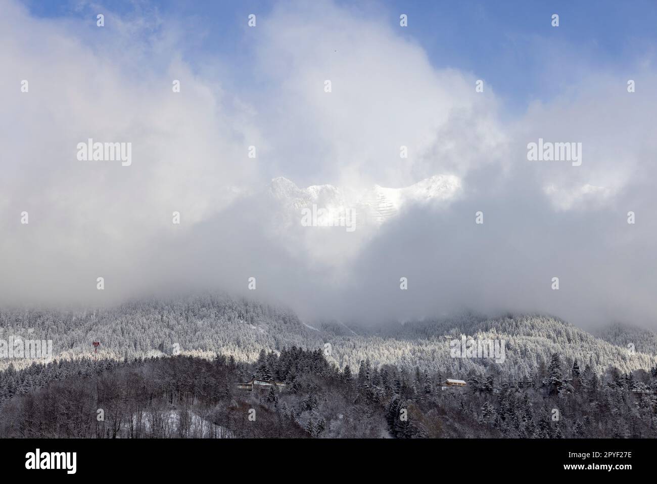 View of the snow peaks of the Alps mountains above the city, clouds ...